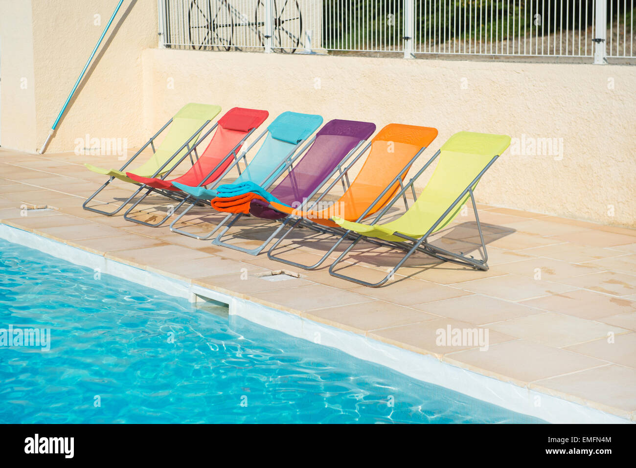 Row colorful chairs at the swimming pool Stock Photo - Alamy