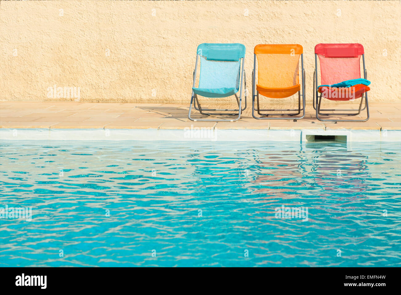 Row colorful chairs at the swimming pool Stock Photo - Alamy