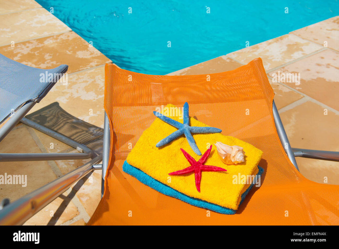 colorful chairs with towels and star fish at the swimming pool Stock ...