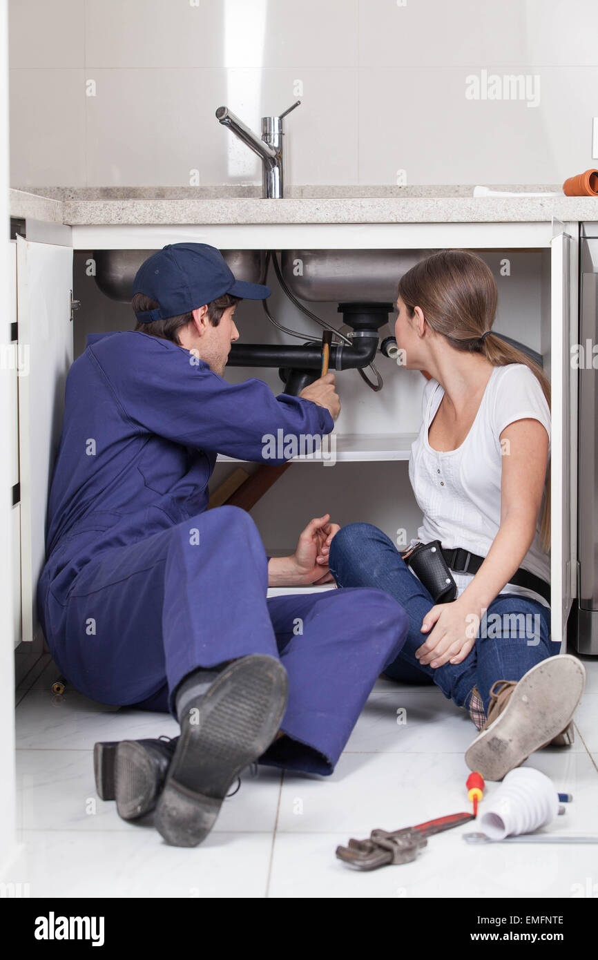 Two plumbers working Stock Photo - Alamy