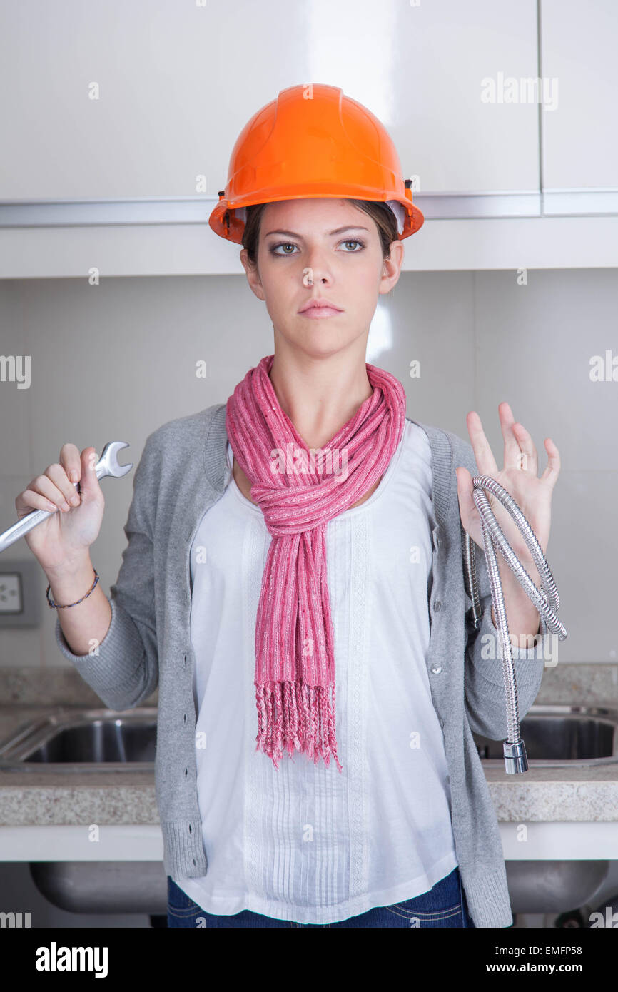 Woman plumber in the kitchen Stock Photo - Alamy