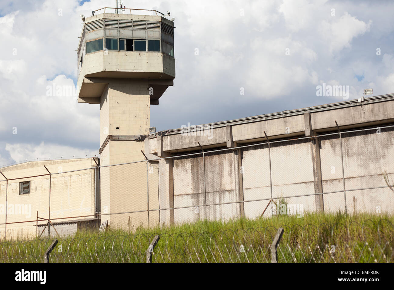 Jail tower and walls surrounded by wires Stock Photo - Alamy