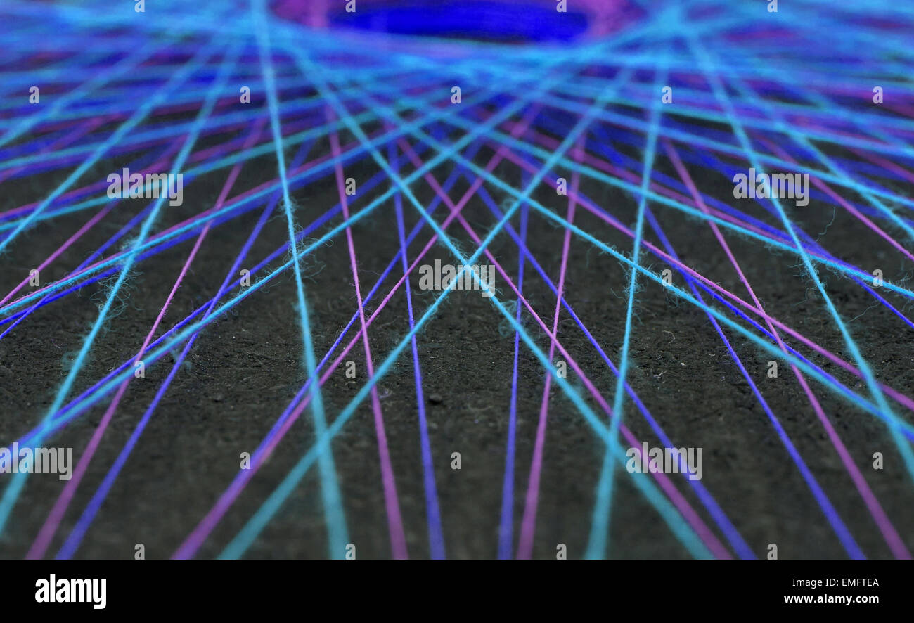 Display of colorful threads on a black panel Stock Photo - Alamy