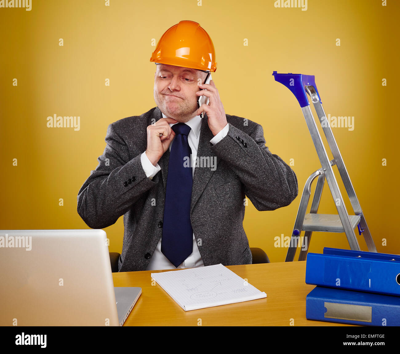 Working male engineer in office, he wearing a white shirt and tie and ...