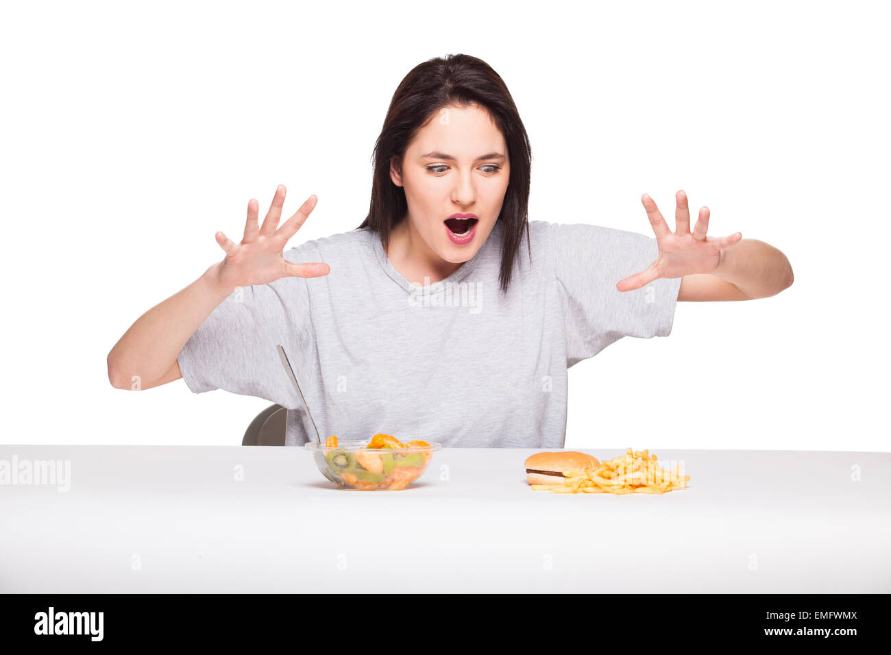 healthy versus junk food concept with a natural woman heaving in front ...