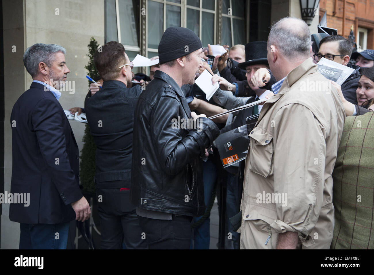 Rock band U2 sign autographs for fans outside the Claridge's Hotel ...