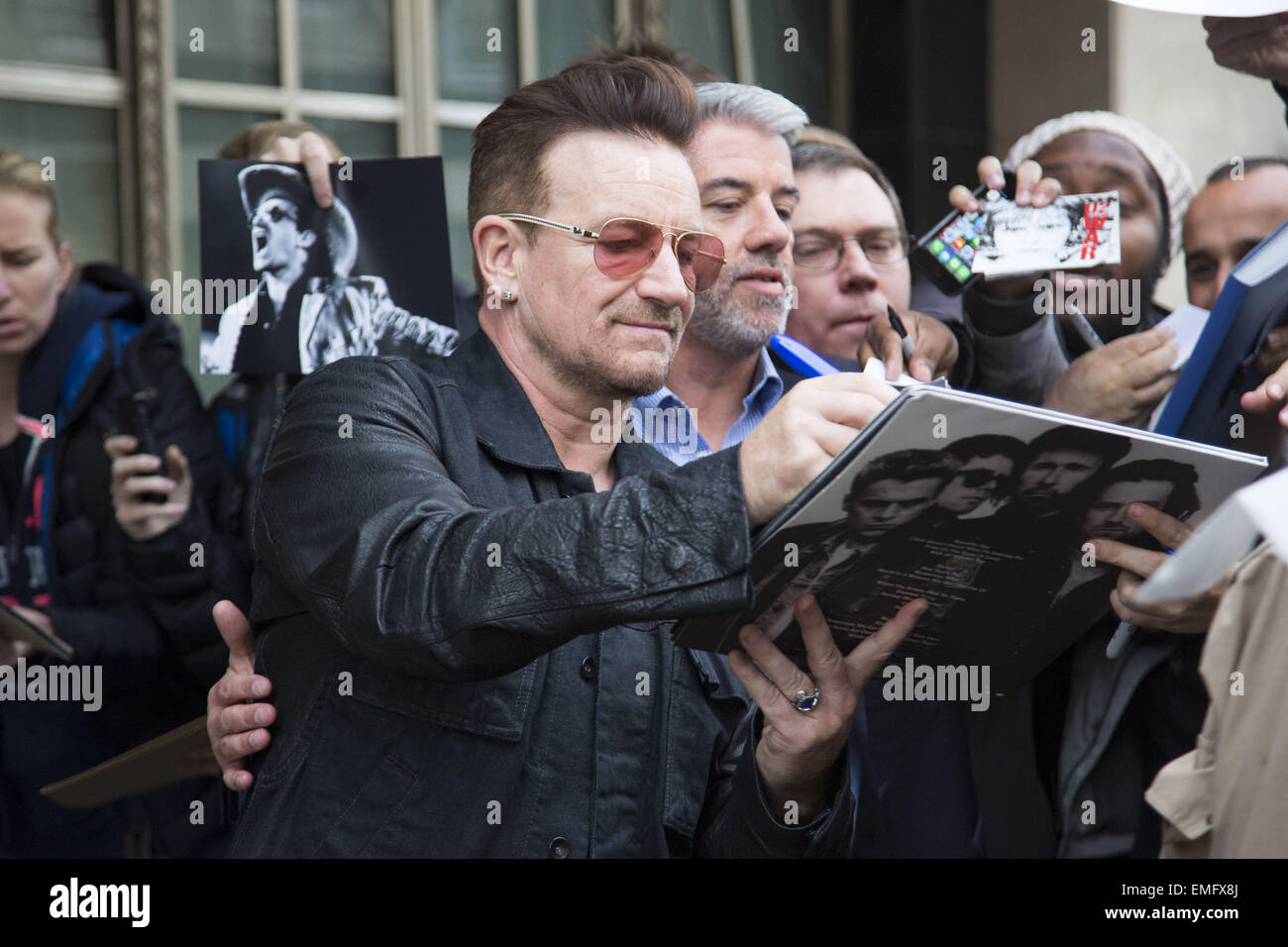 Rock band U2 sign autographs for fans outside the Claridge's Hotel ...