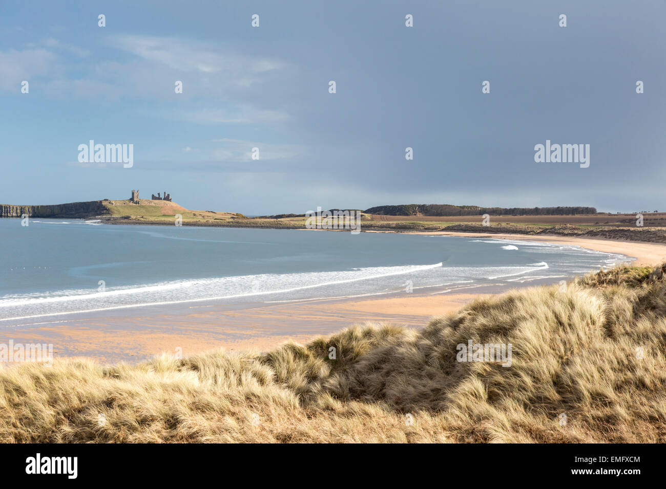 Dunstanburgh Castle across Embleton Bay on the north east coast of ...