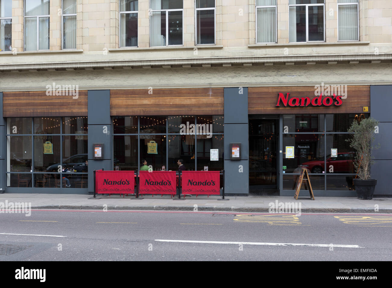A branch of Nando's restaurant on Commercial Street London Stock Photo ...