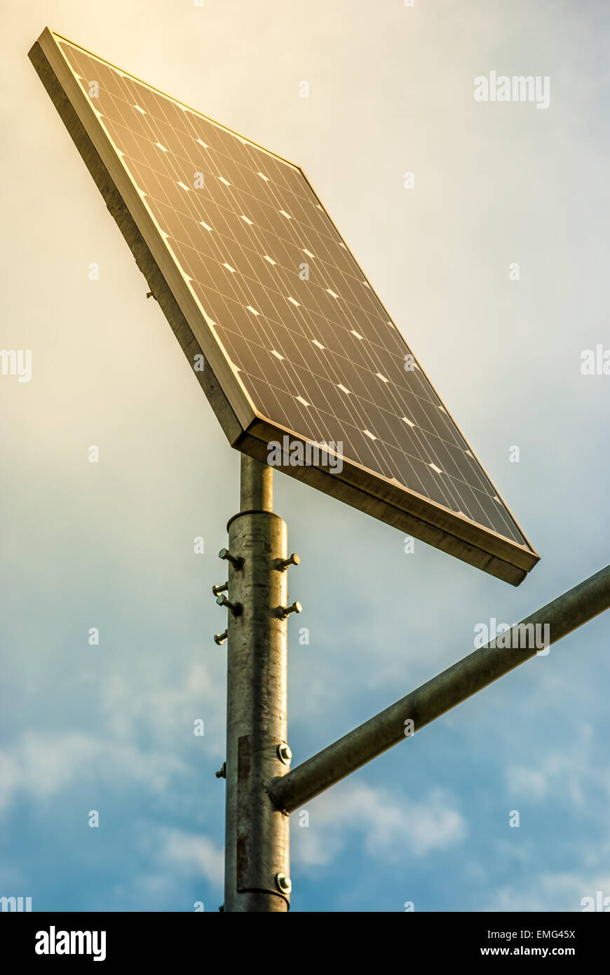 Sun shining in a solar panel of a lantern in park against sky Stock ...