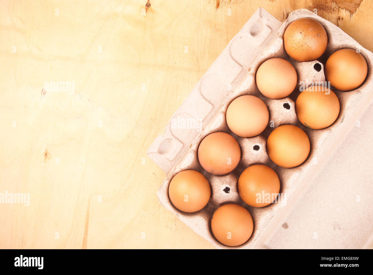 ten chicken eggs in the container on wood, background with space for ...