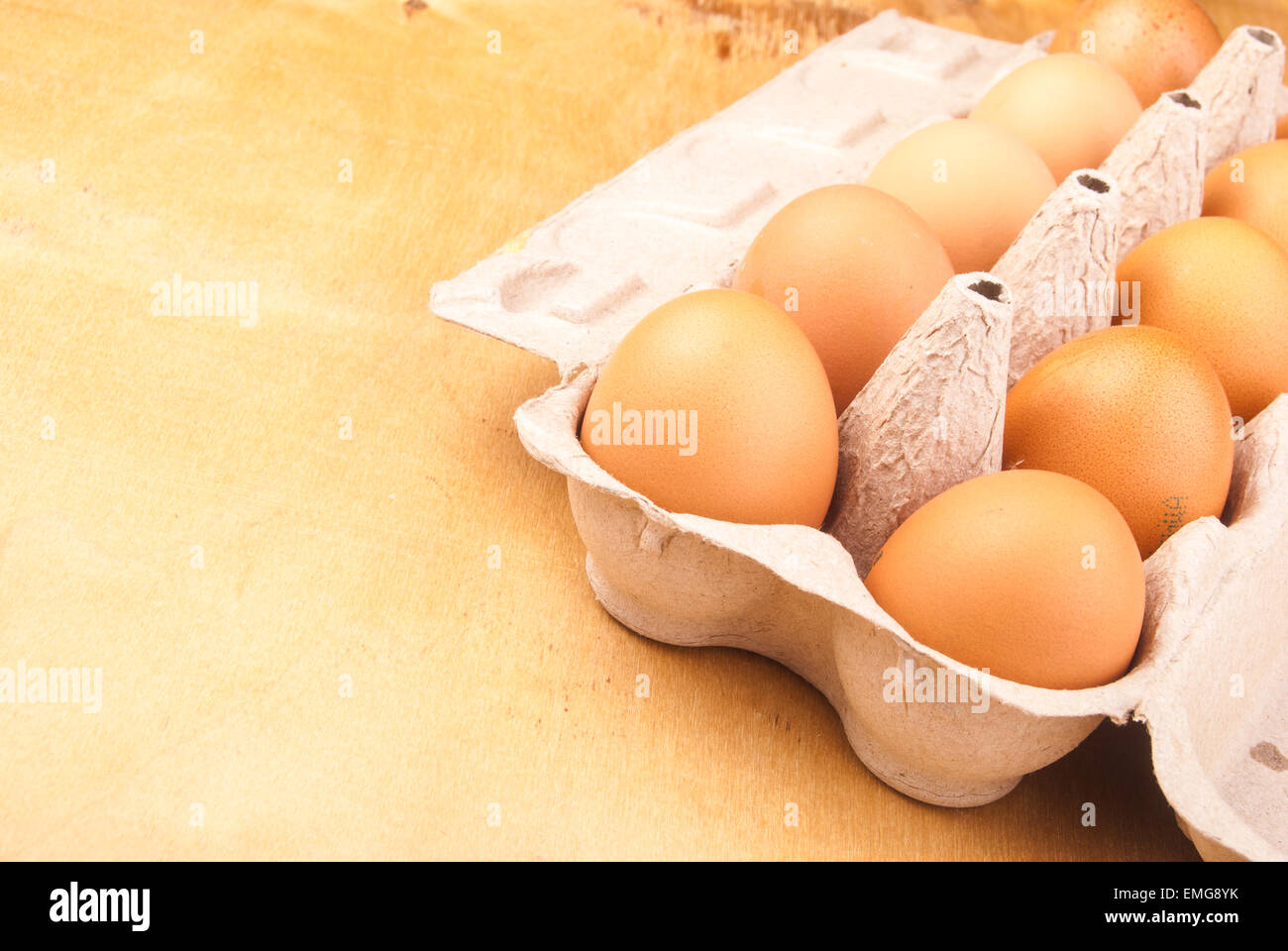 ten chicken eggs in the container on wood, background with space for ...