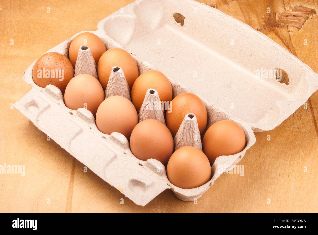ten chicken eggs in the container on wood, background with space for ...