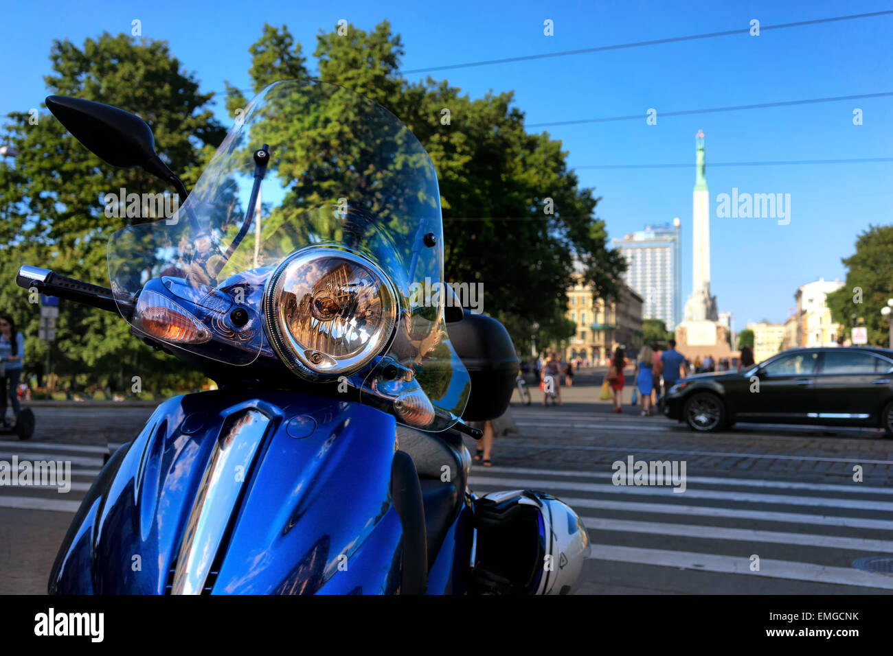 Blue scooter on the background of the Freedom Monument and blue sky in ...