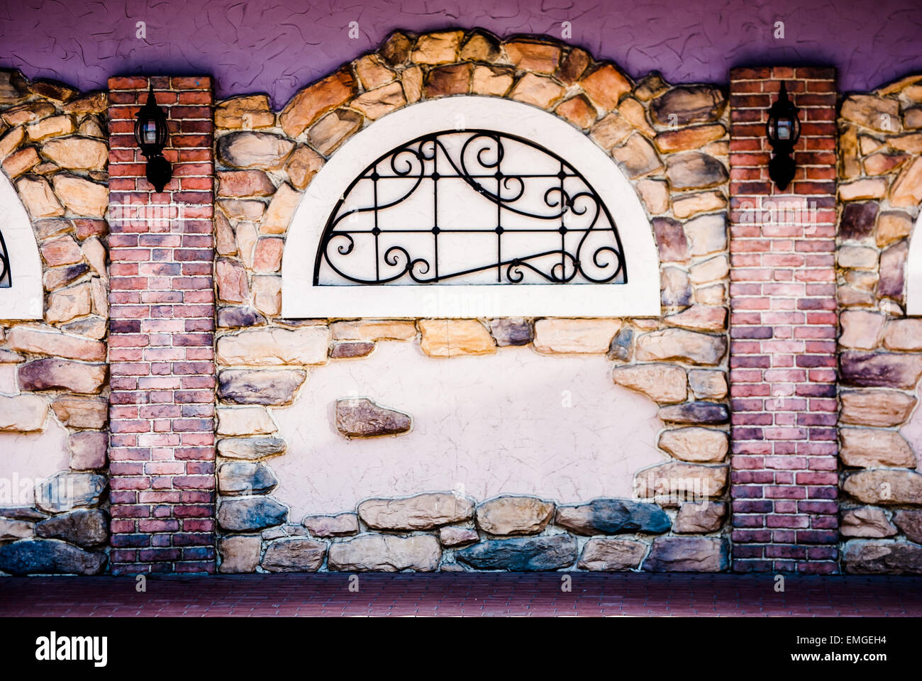 Arch in a decorative brick stone wall Stock Photo - Alamy