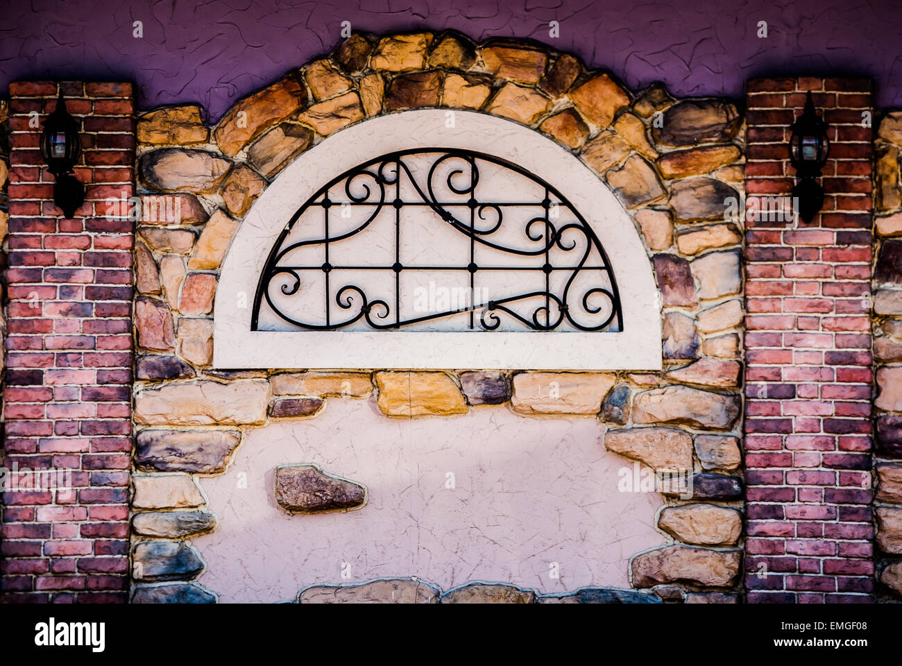 Arch in a decorative brick stone wall Stock Photo - Alamy