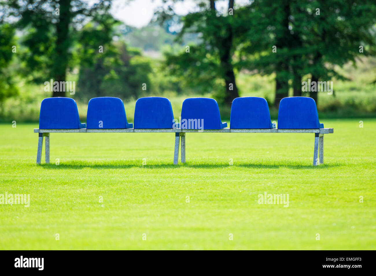 blue plastic bench on green grass Stock Photo - Alamy