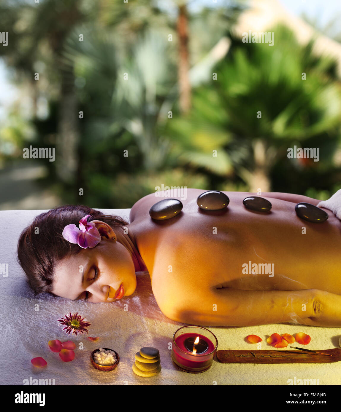 Young woman getting stone massage procedure Stock Photo - Alamy