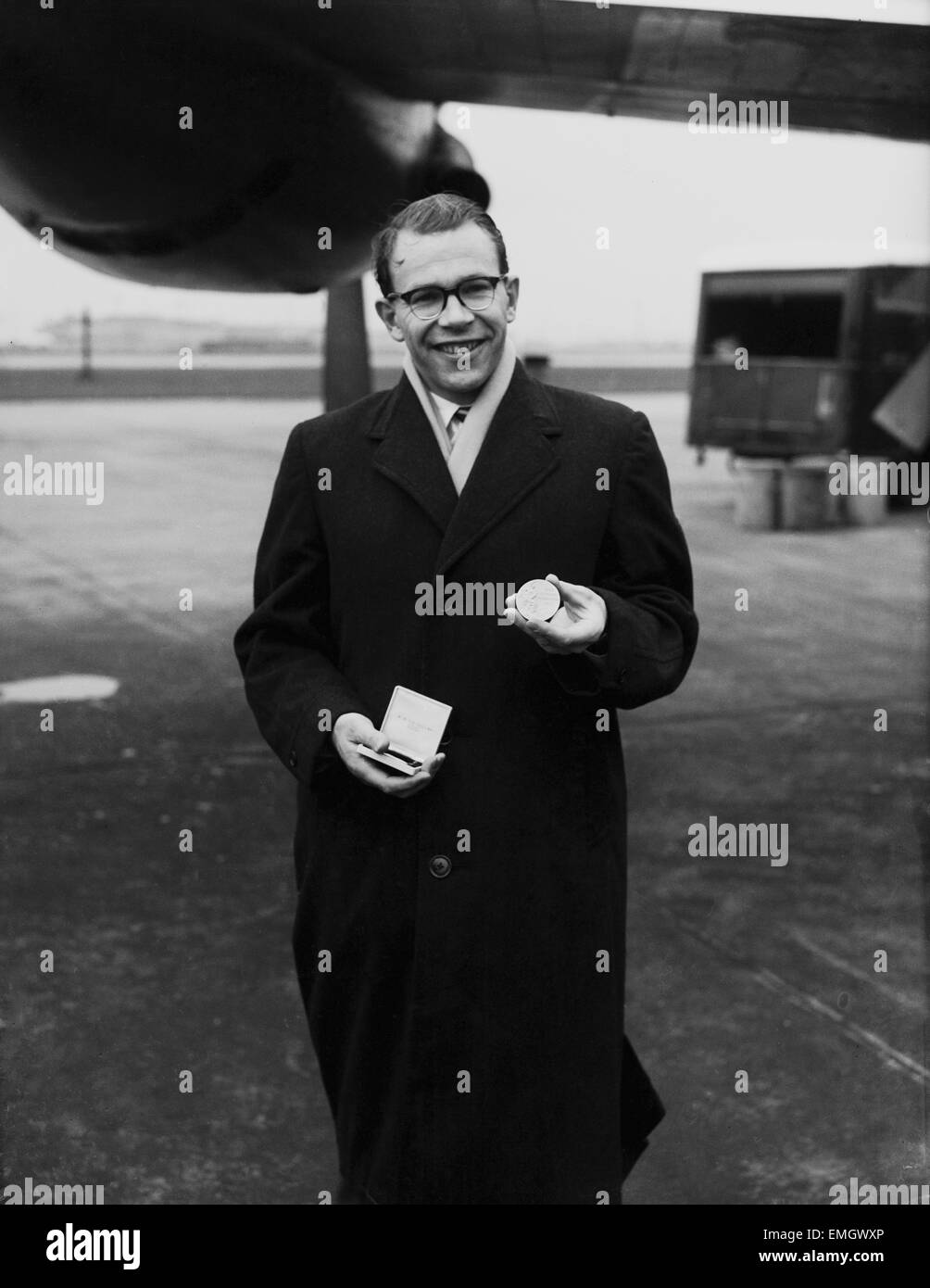 British athlete Chris Brasher shows off his gold medal which he won at ...