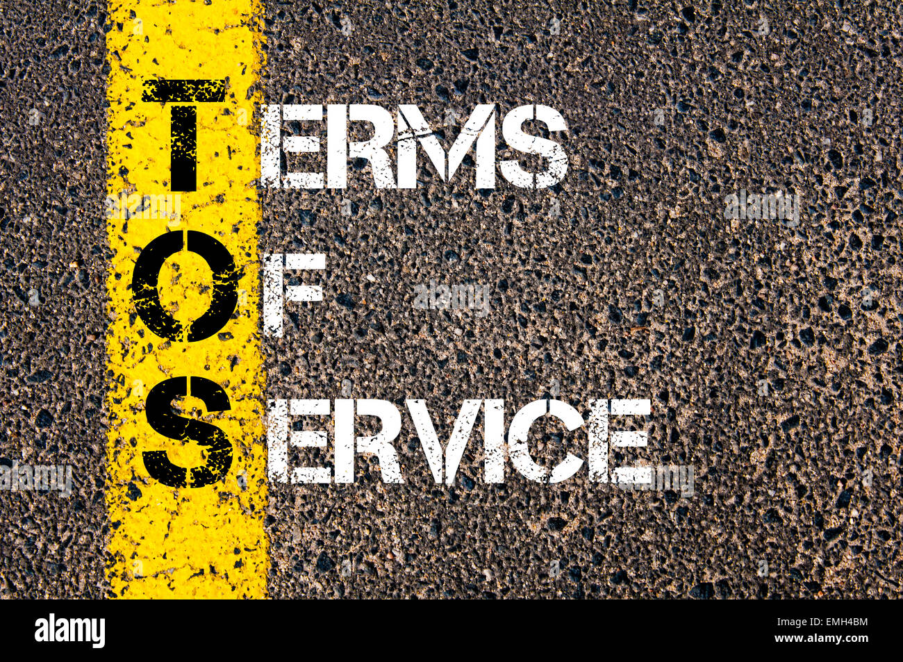 Business Acronym TOS as TERMS OF SERVICE. Yellow paint line on the road ...