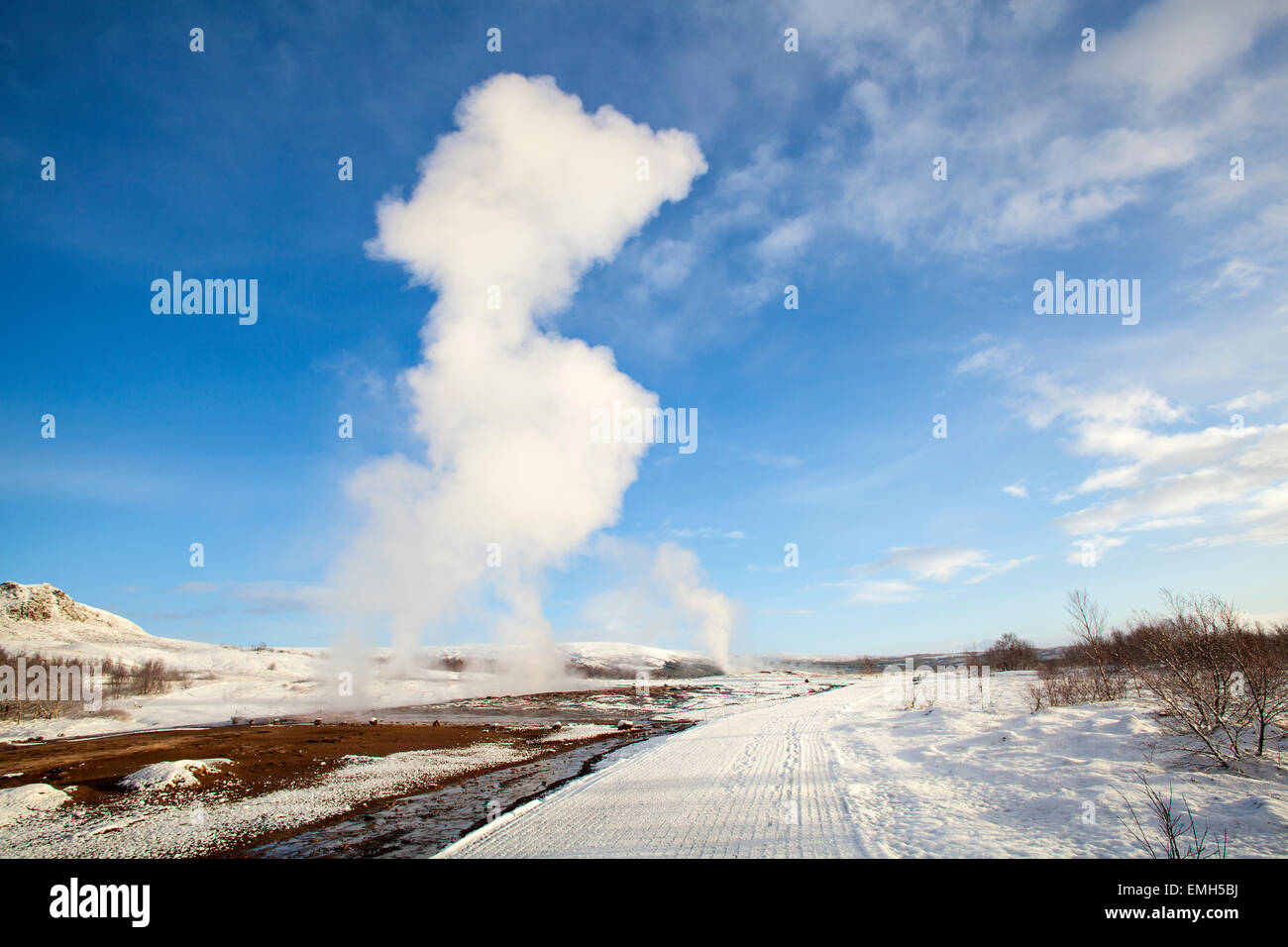 Geyser eruption of Strokkur in Iceland with blue sky in winter Stock ...