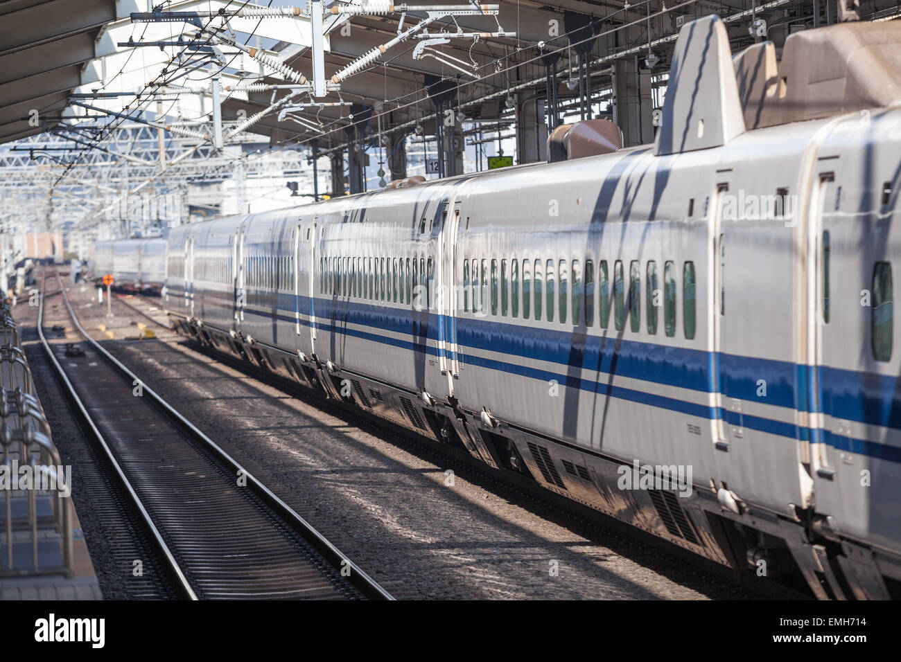 Tokyo rail station. Shinkansen high-speed train is near empty platform ...