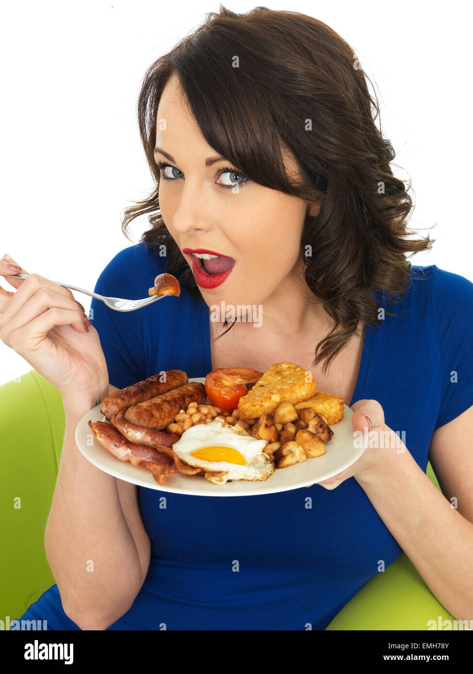 Young Confident Woman With Dark Hair Eating A Traditional Fried Full ...