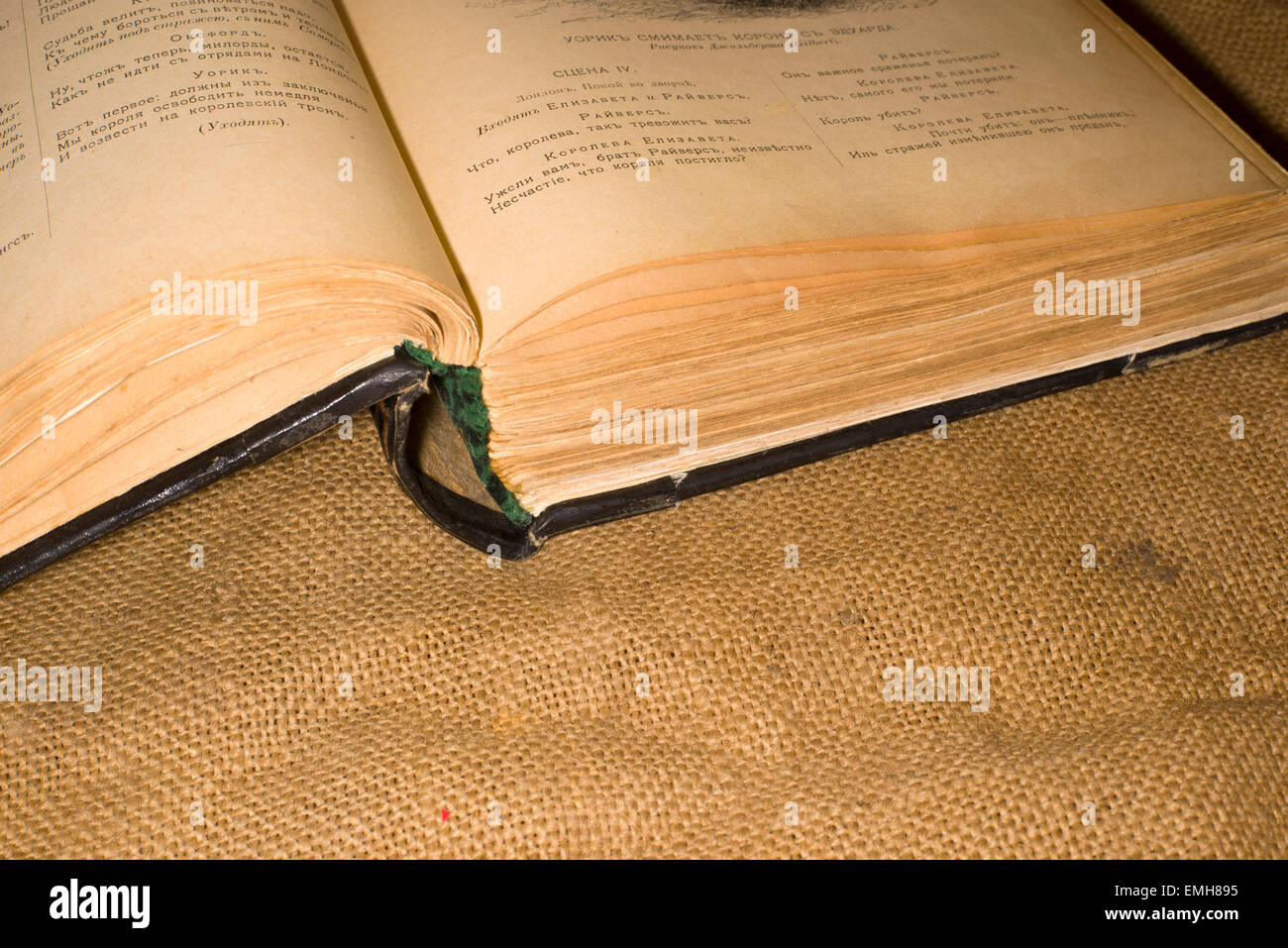On the old sacking is a very old open book Stock Photo - Alamy
