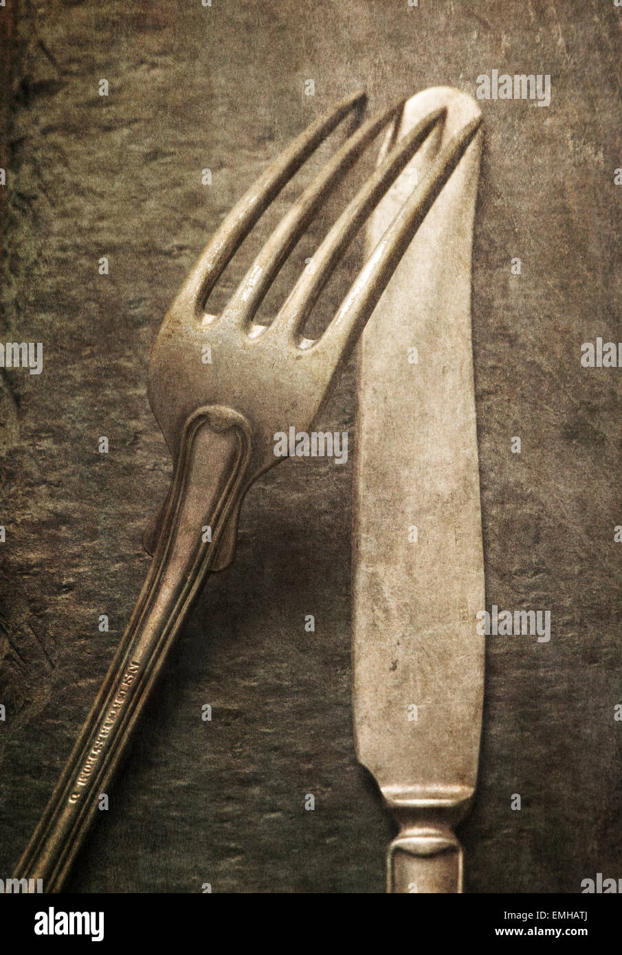 Still life with silverware on table. Knife and fork on a stone ...