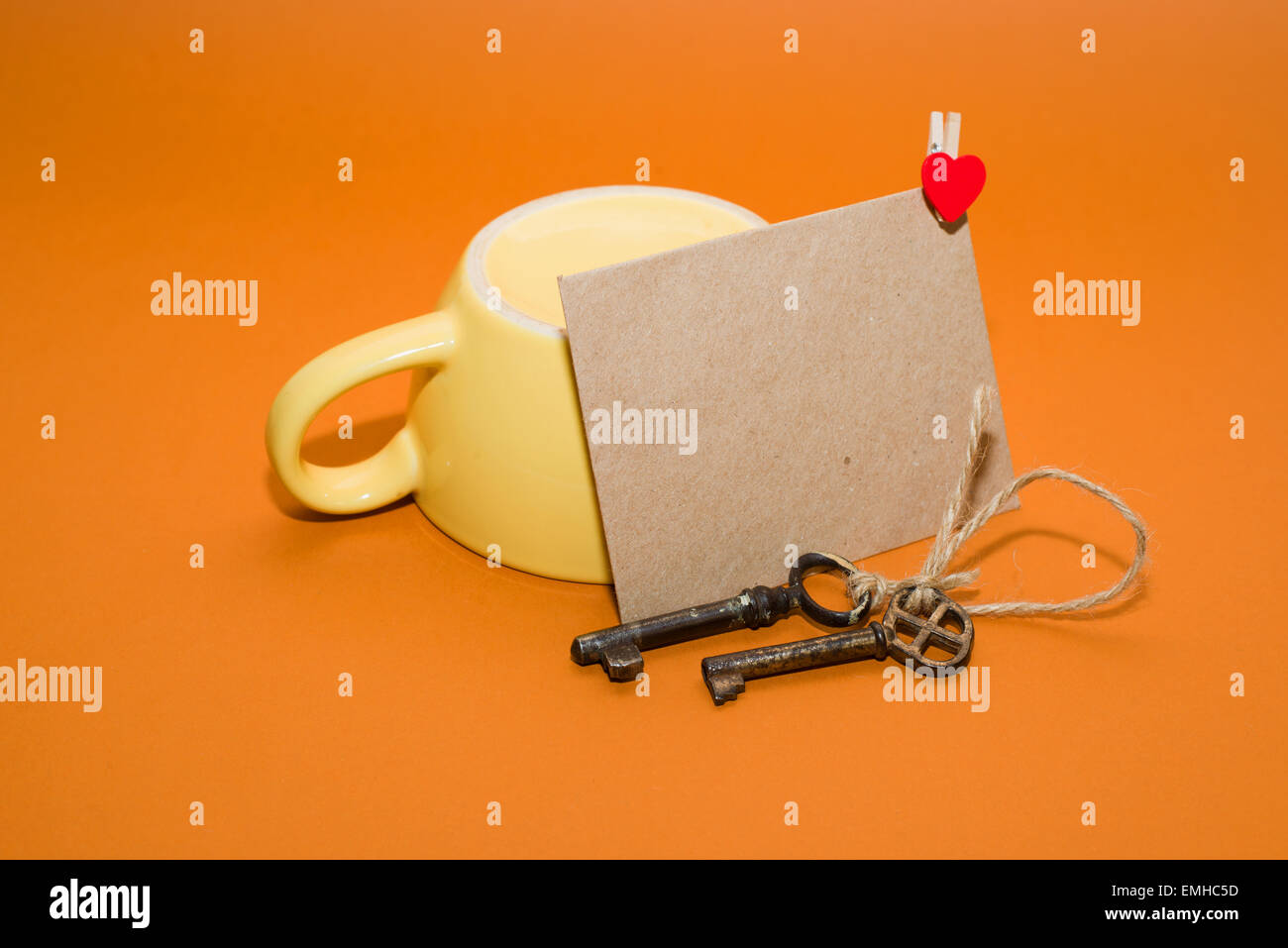 Two keys, cup and envelope on an orange background Stock Photo - Alamy