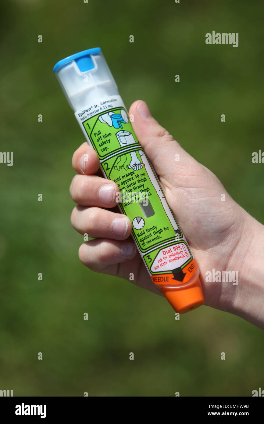 A boy using an Epipen in his thigh demonstrating what to do in the ...