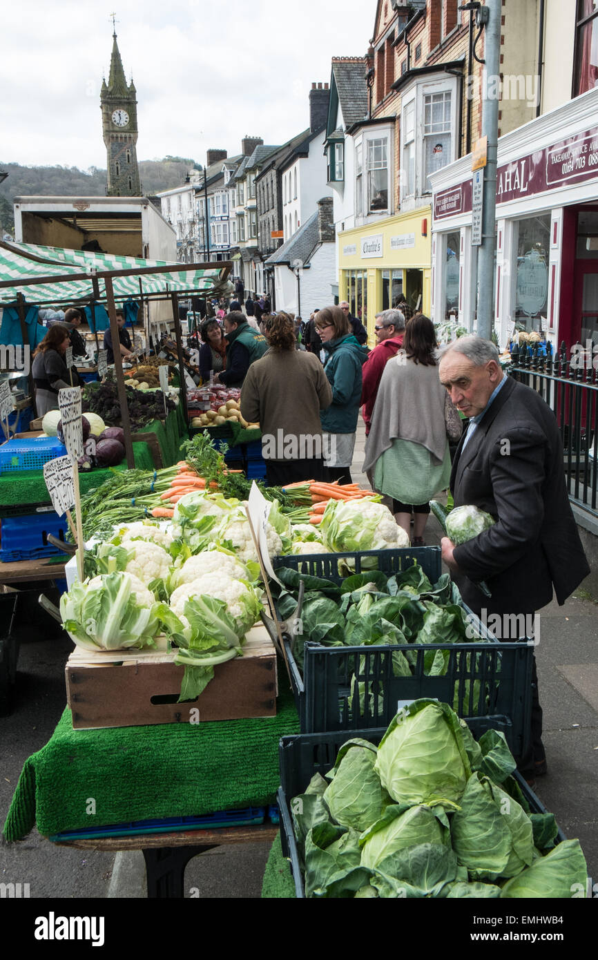 Clock tower and stalls in Machynlleth market town on weekly market day ...