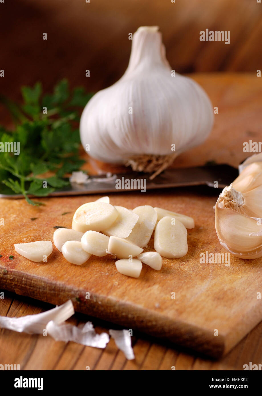 sliced garlic on wooden chopping board Stock Photo - Alamy