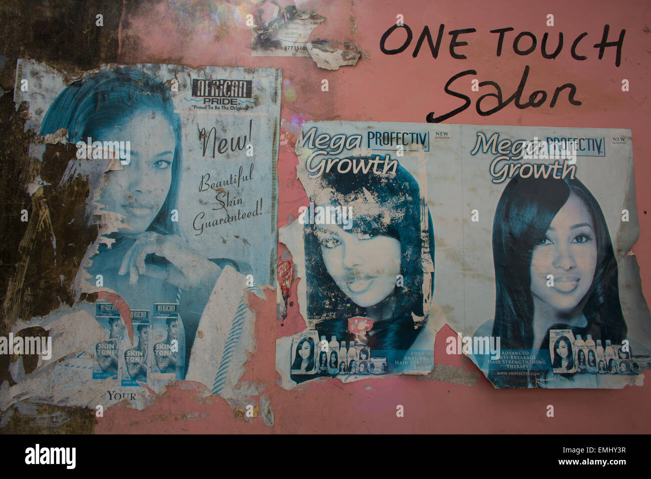 faded posters on beauty salon in Zanzibar Stock Photo - Alamy