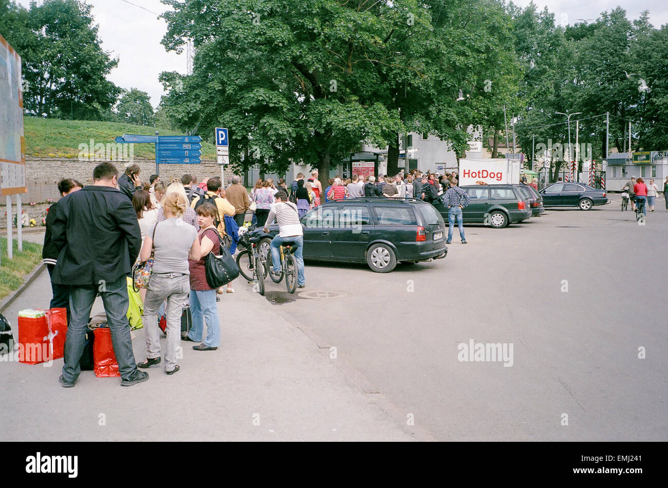 People waiting in a line to cross the border in the Narva town from ...