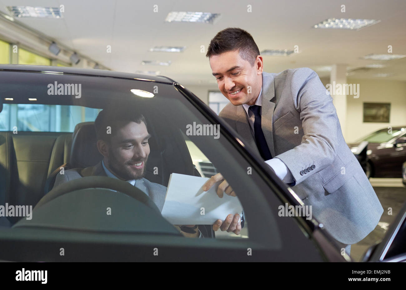 happy man with car dealer in auto show or salon Stock Photo - Alamy