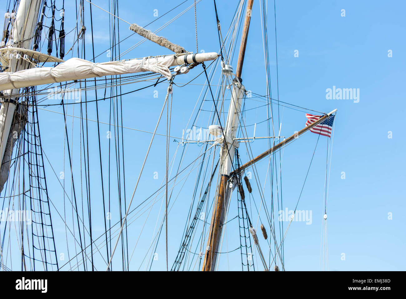 masts, rigging and rolled up sails of a tall sailboat Stock Photo - Alamy