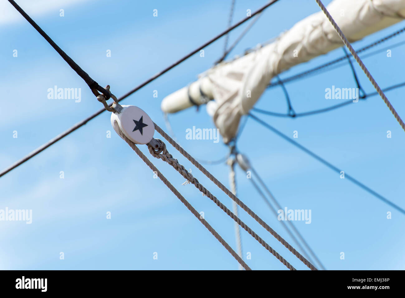 masts, rigging and rolled up sails of a tall sailboat Stock Photo - Alamy