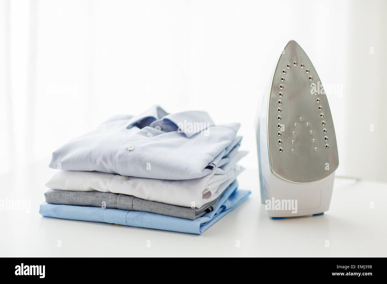 close up of iron and clothes on table at home Stock Photo - Alamy