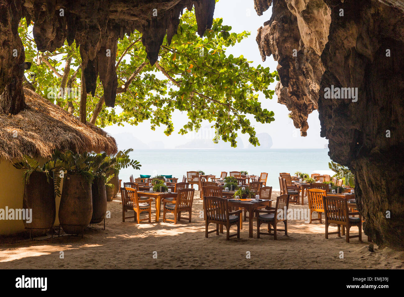 view to open-air restaurant on beach from cave Stock Photo - Alamy