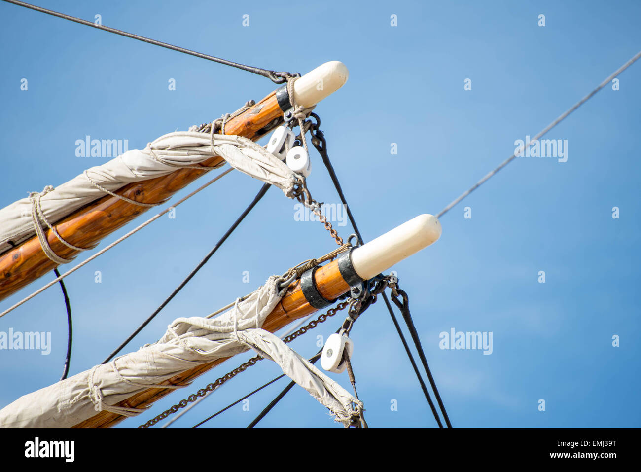 masts, rigging and rolled up sails of a tall sailboat Stock Photo - Alamy
