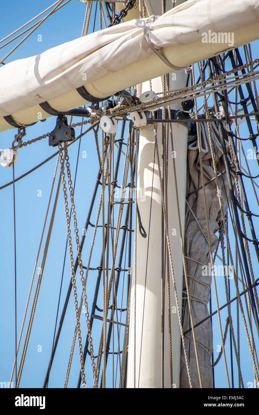 masts, rigging and rolled up sails of a tall sailboat Stock Photo - Alamy