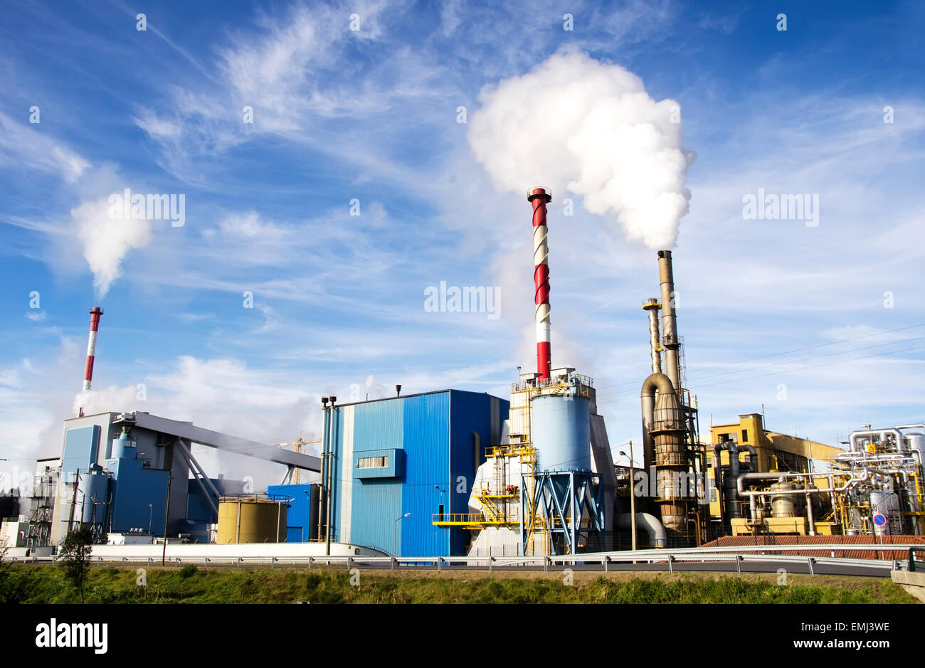 Industrial factory with tall fume towers Stock Photo - Alamy