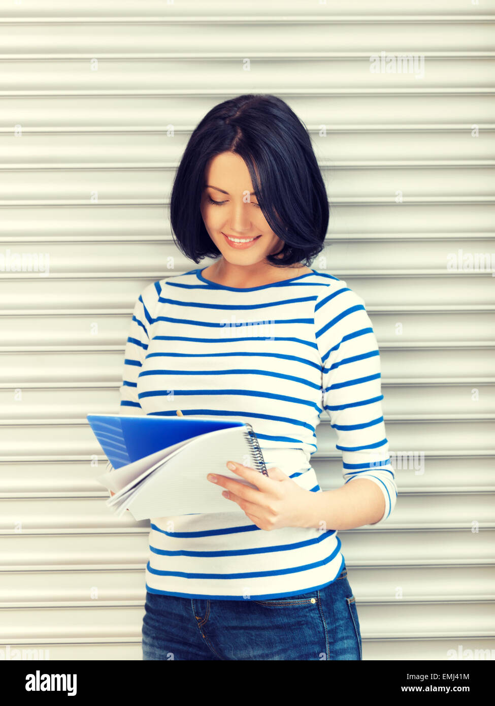happy and smiling teenage girl with big notepad Stock Photo - Alamy