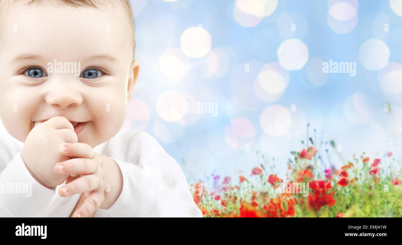 beautiful happy baby over poppy field background Stock Photo - Alamy