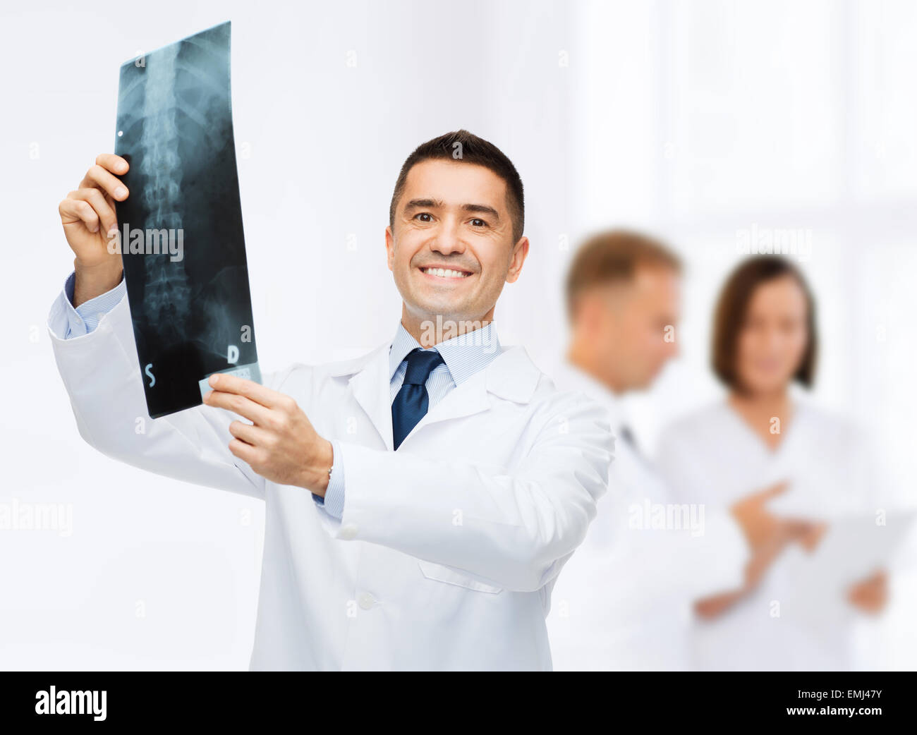 smiling male doctor holding x-ray at hospital Stock Photo - Alamy