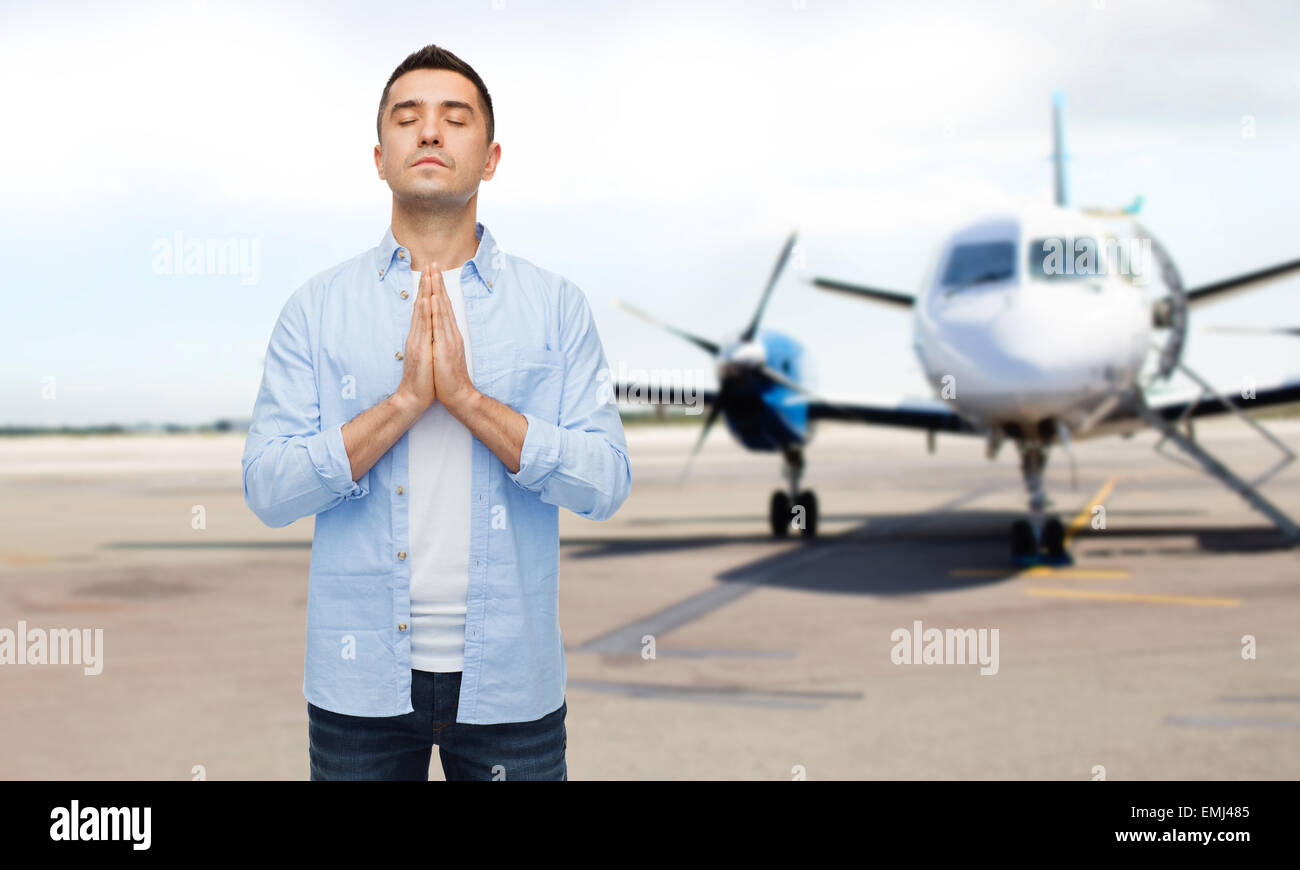 man praying over airplane on runway background Stock Photo - Alamy