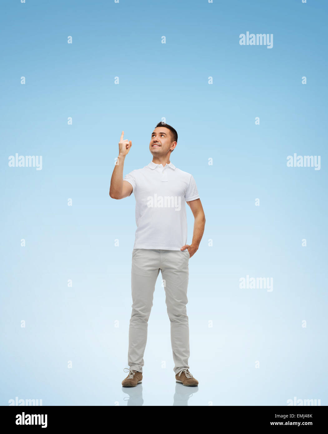 smiling man pointing finger up Stock Photo - Alamy