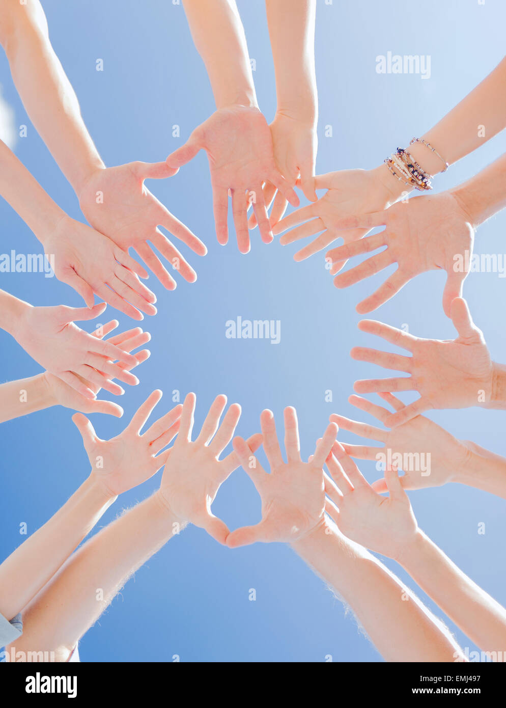 many hands over blue sky background Stock Photo - Alamy