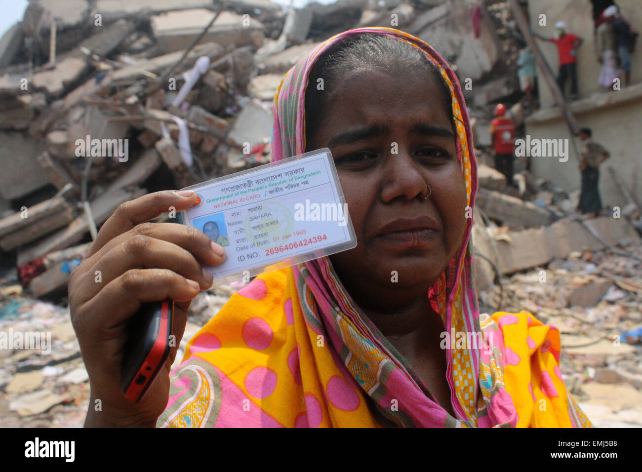 Women cry as others hold a portrait of her missing relative at the site ...